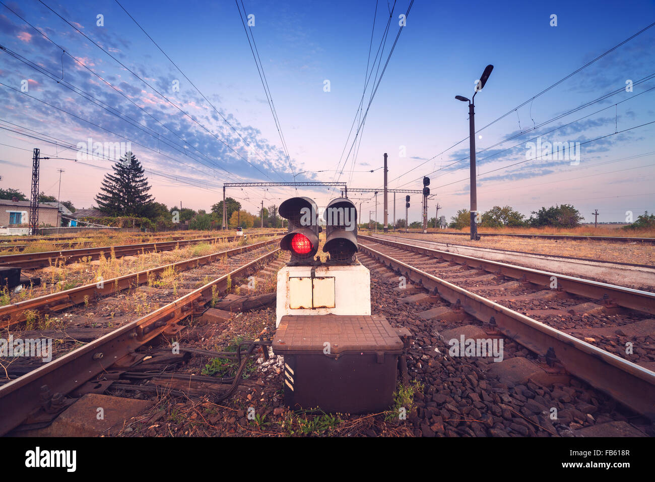 Train platform and traffic light at sunset. Railroad. Railway station ...