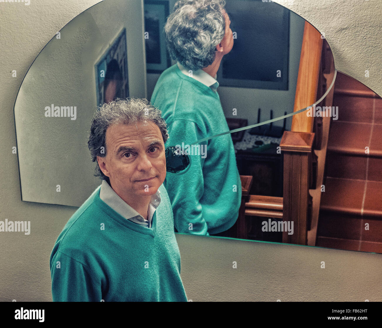 middle-aged man at home with mirror behind Stock Photo - Alamy