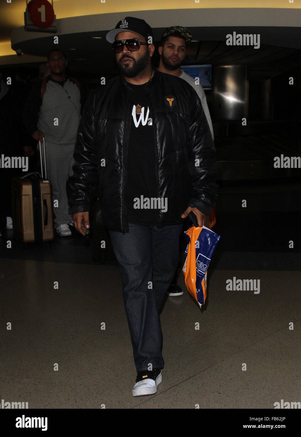Ice Cube arrives at Los Angeles International Airport with his son O ...