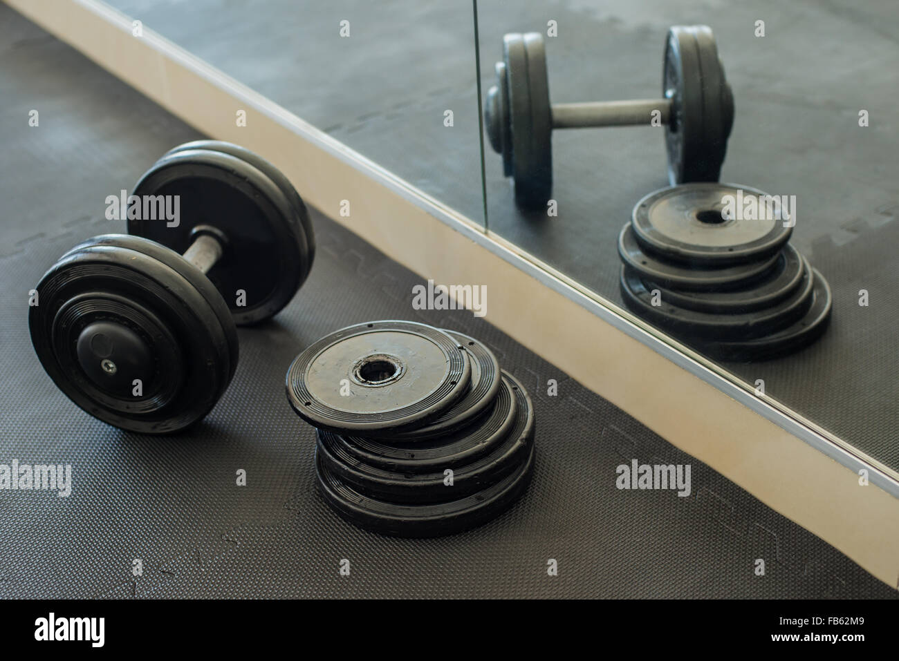Barbells weight plate in gym Stock Photo - Alamy