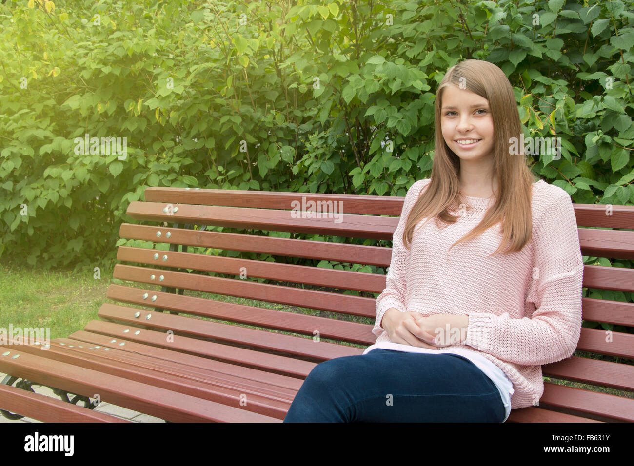 Beautiful teenager girl on the bench Stock Photo - Alamy