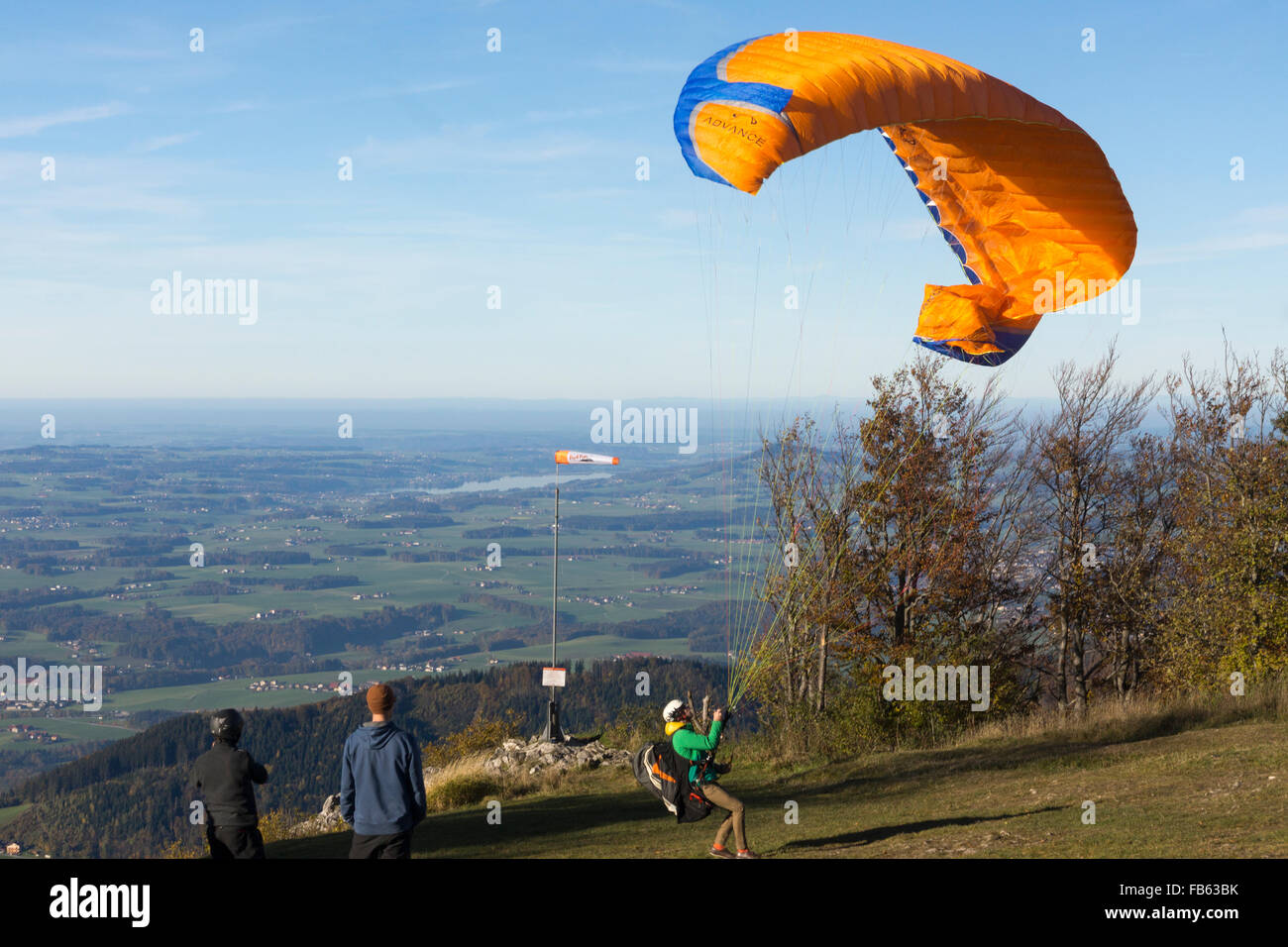A paraglider attempting to inflate his wing as he attempts a reverse ...