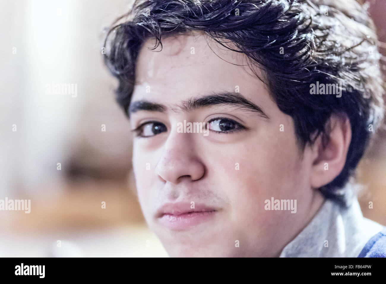 close portrait of Caucasian boy with reassuring look in warm and bright ...