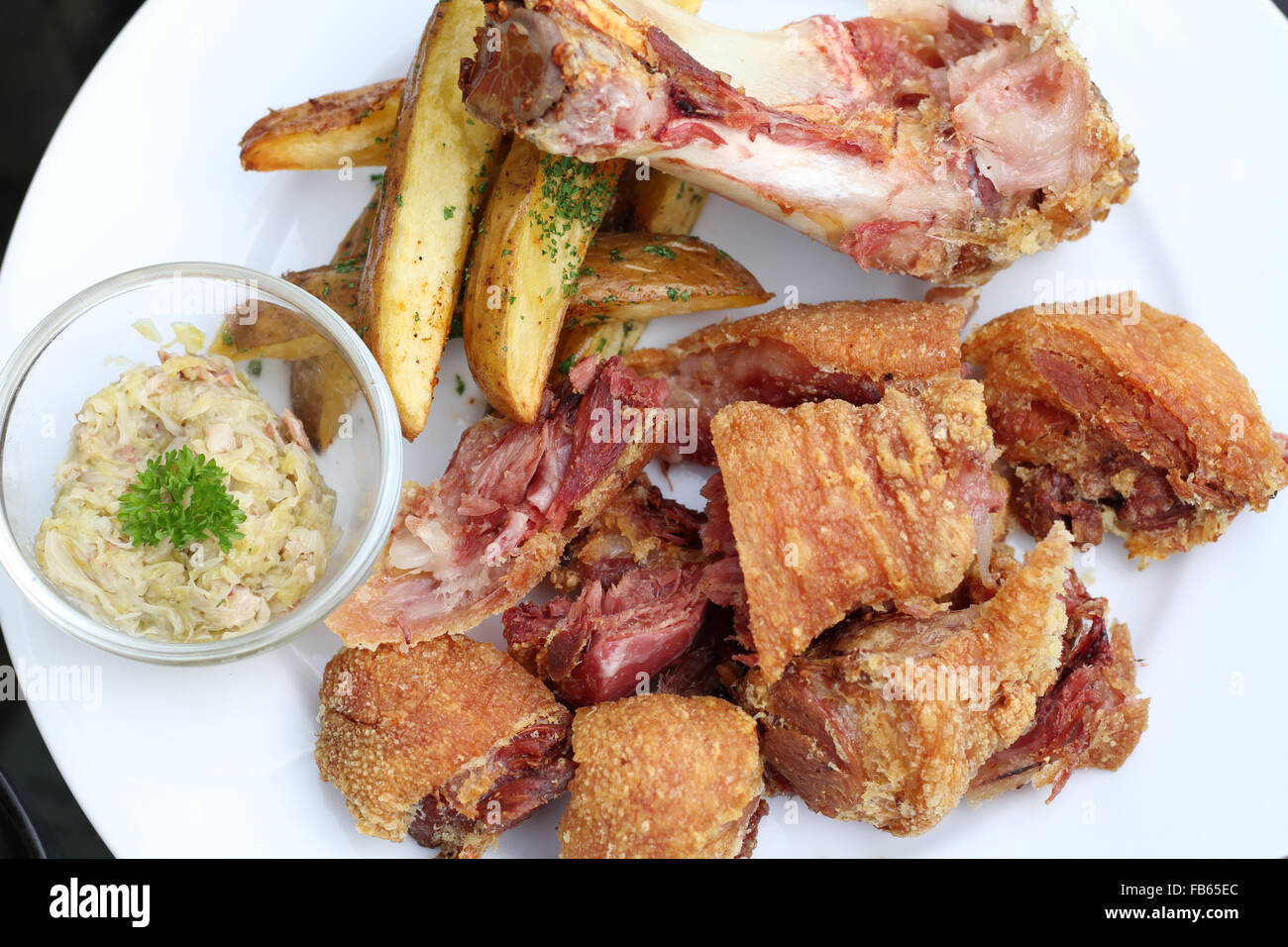 German BBQ pork knuckle served with sauerkraut Stock Photo - Alamy