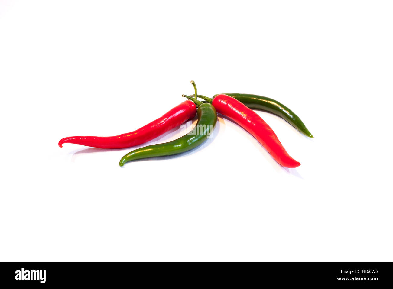 Two green and two red chillies on white background Stock Photo - Alamy