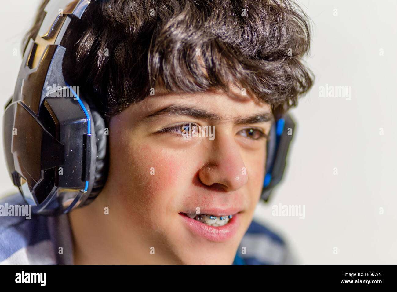 boy with wearing headphones while playing with video games Stock Photo ...
