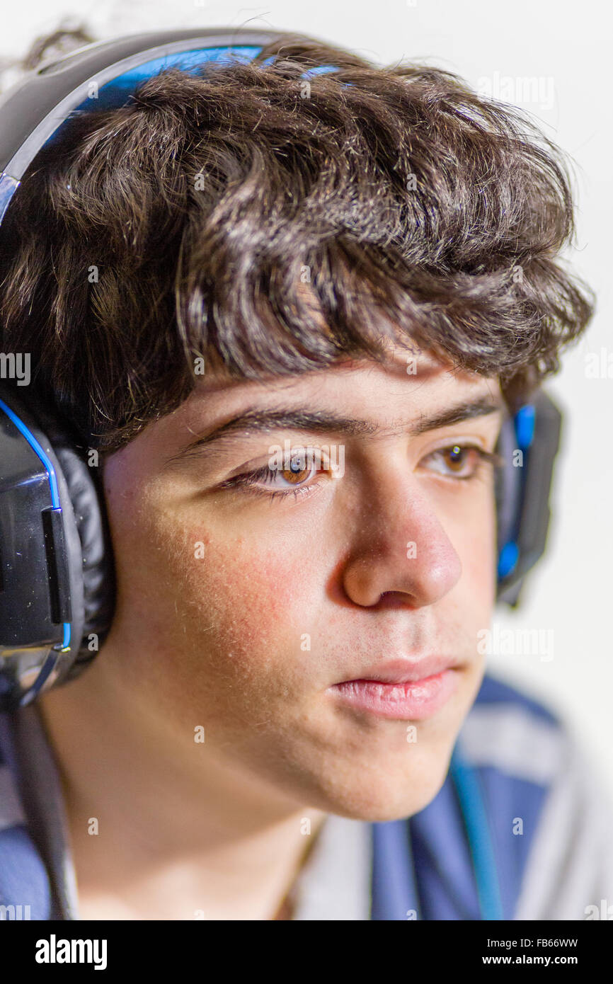 boy with wearing headphones while playing with video games Stock Photo ...