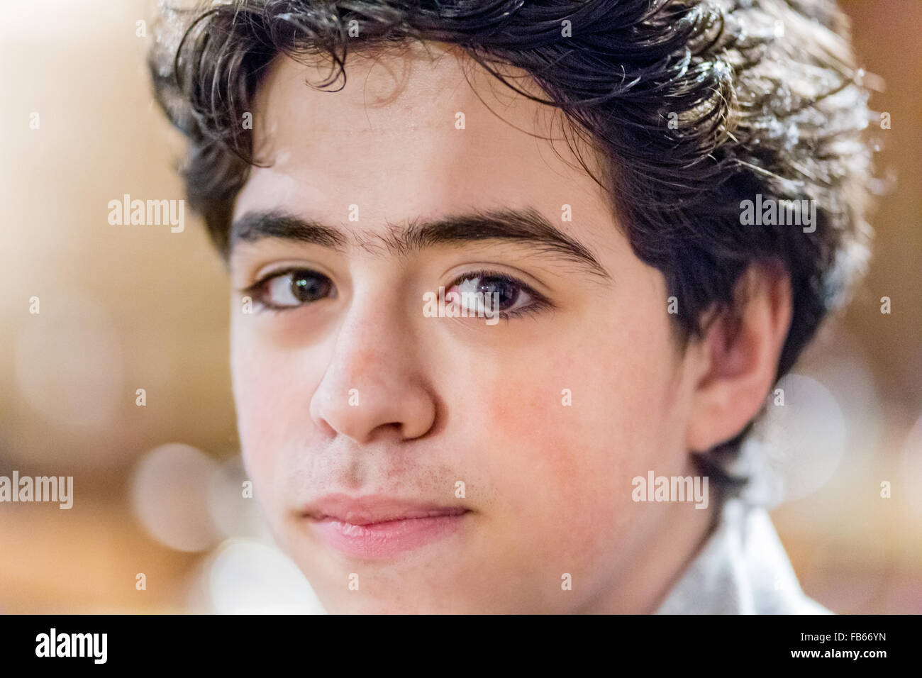 close portrait of Caucasian boy with reassuring look in warm and bright ...