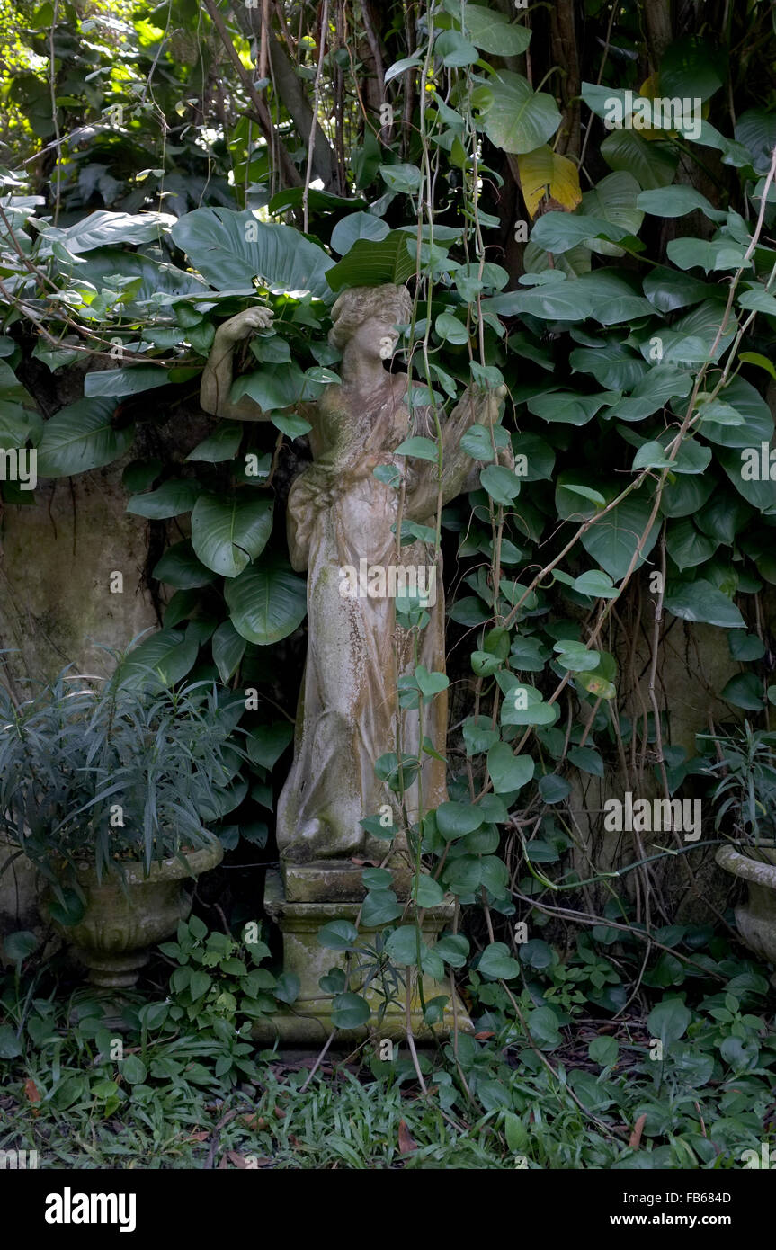 Sculpture covered with moss in garden Stock Photo - Alamy