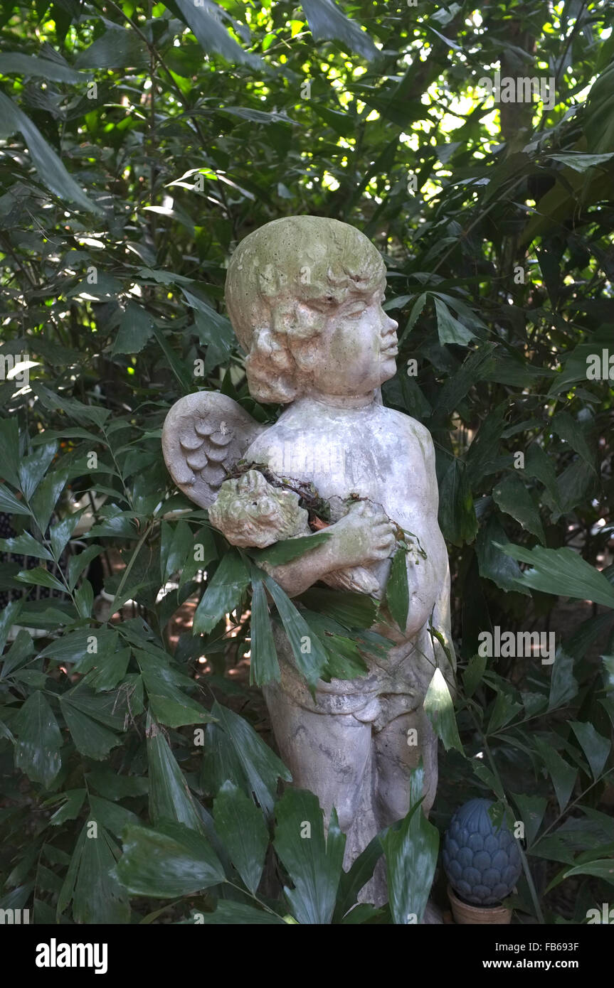 Sculpture covered with moss in garden Stock Photo - Alamy