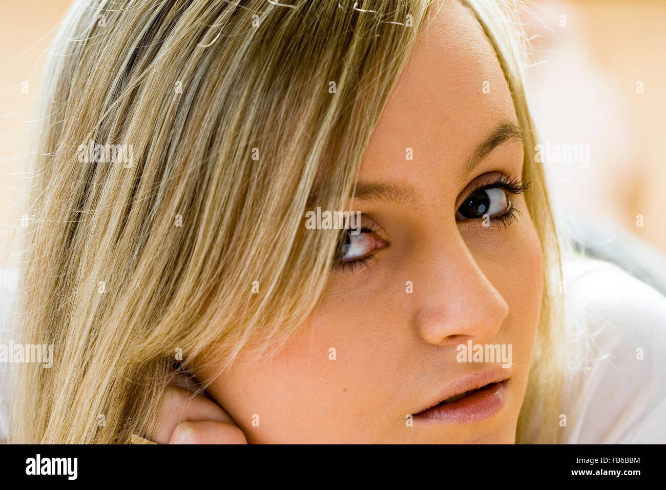 Beautiful blonde teenage girl, 16 years, with blue eyes. Face half ...