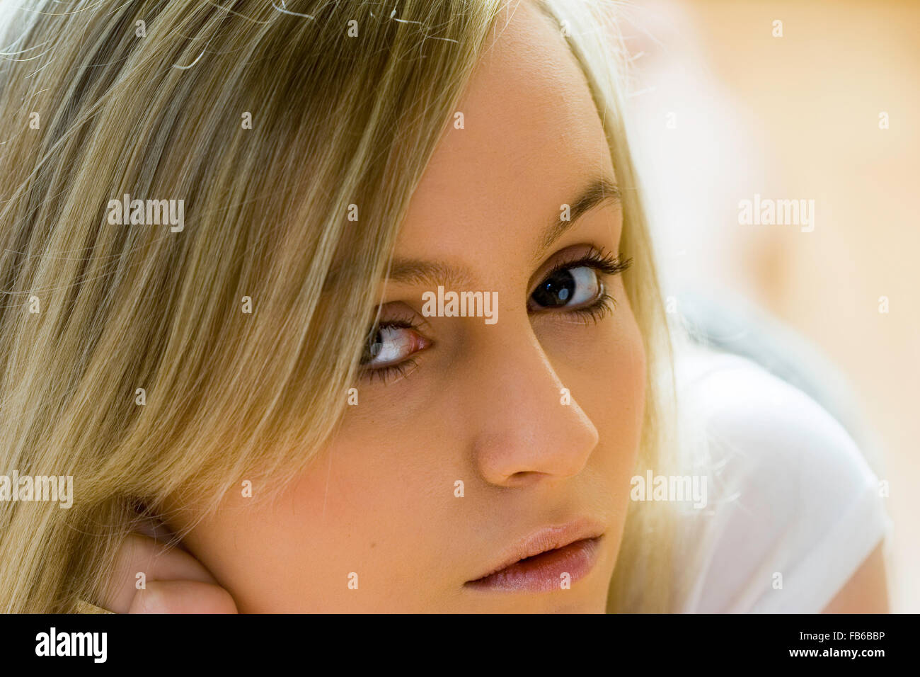 Beautiful blonde teenage girl, 16 years, with blue eyes. Face half ...