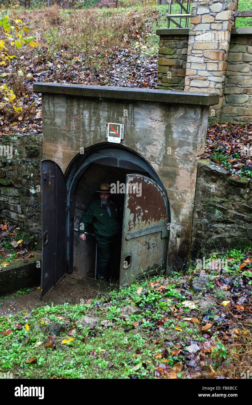 A park ranger stands insides the Carmichael entrance, Mammoth Cave ...