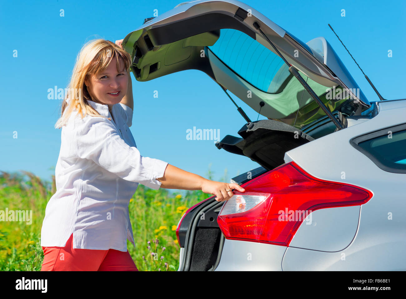 Woman loading car trunk hi-res stock photography and images - Alamy