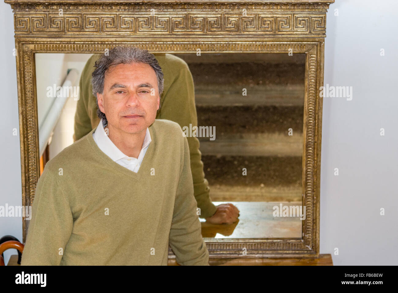 middle-aged man with sleepy, drooping eyelids leaning against large ...