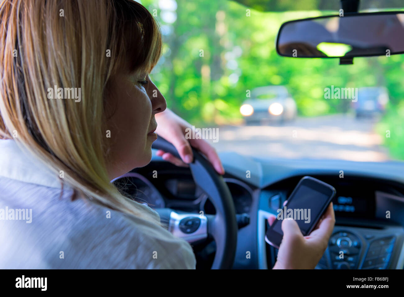 woman driving dangerous on the road Stock Photo - Alamy