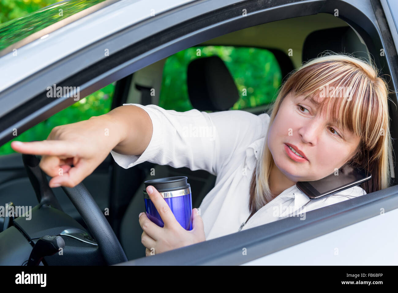 woman 50 years with busy hands driving shows forward Stock Photo - Alamy