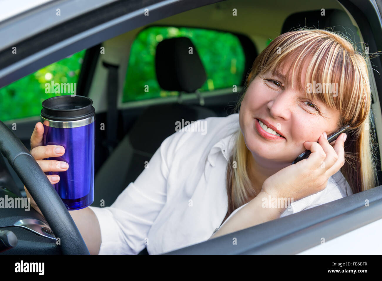 Happy relaxed driver behind the wheel of a car Stock Photo - Alamy