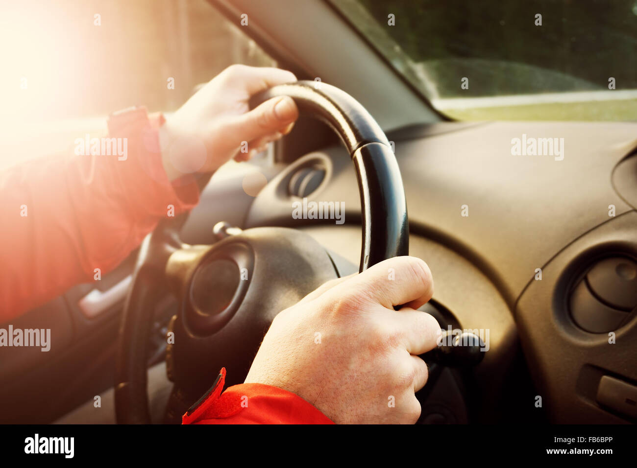 Man hands holding steering wheel Stock Photo - Alamy