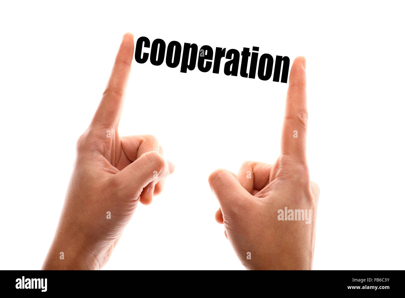 Color horizontal shot of a of a hand squeezing the word "cooperation ...
