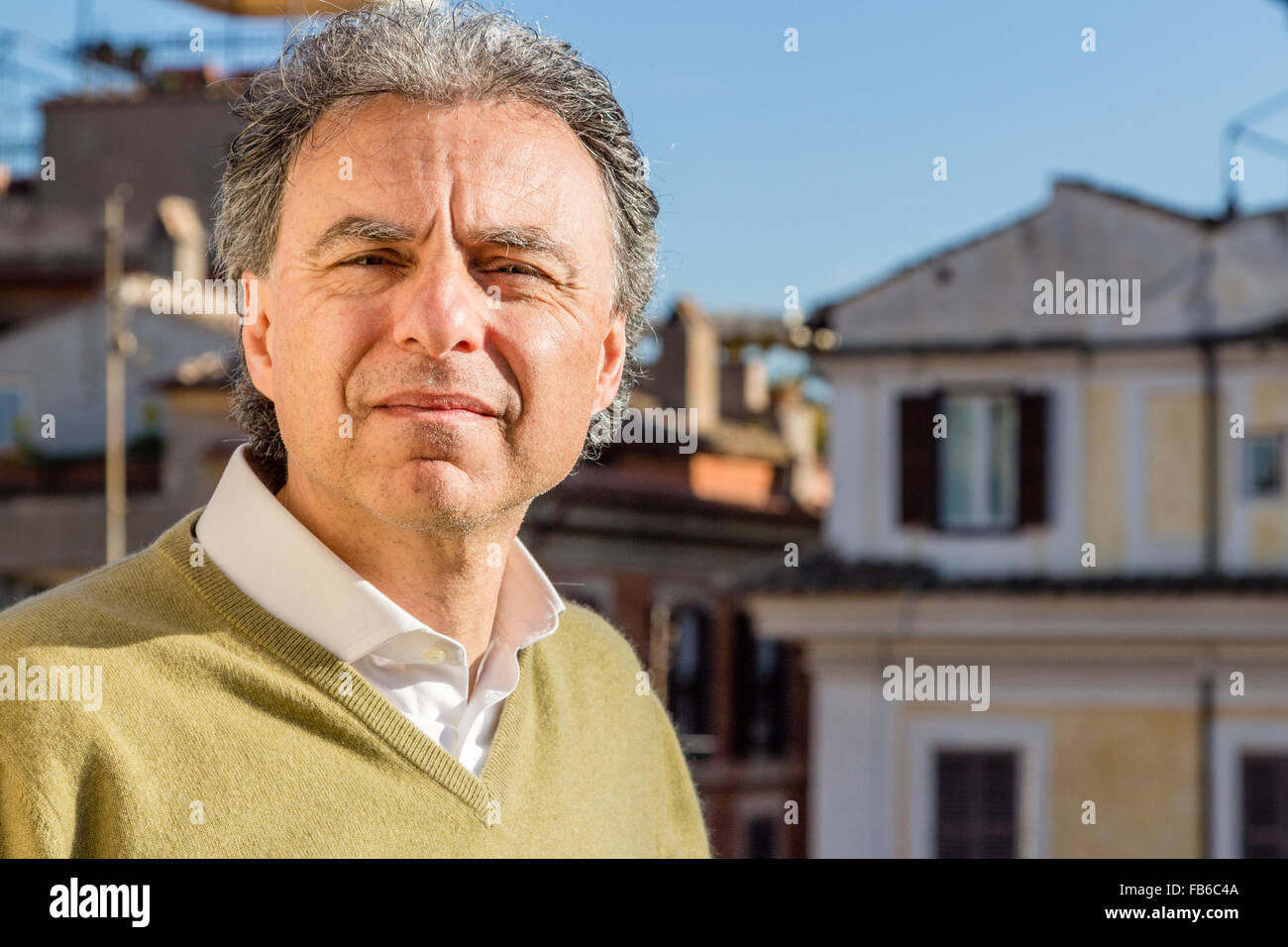 middle-aged man in green polo with the palaces of Rome in the ...
