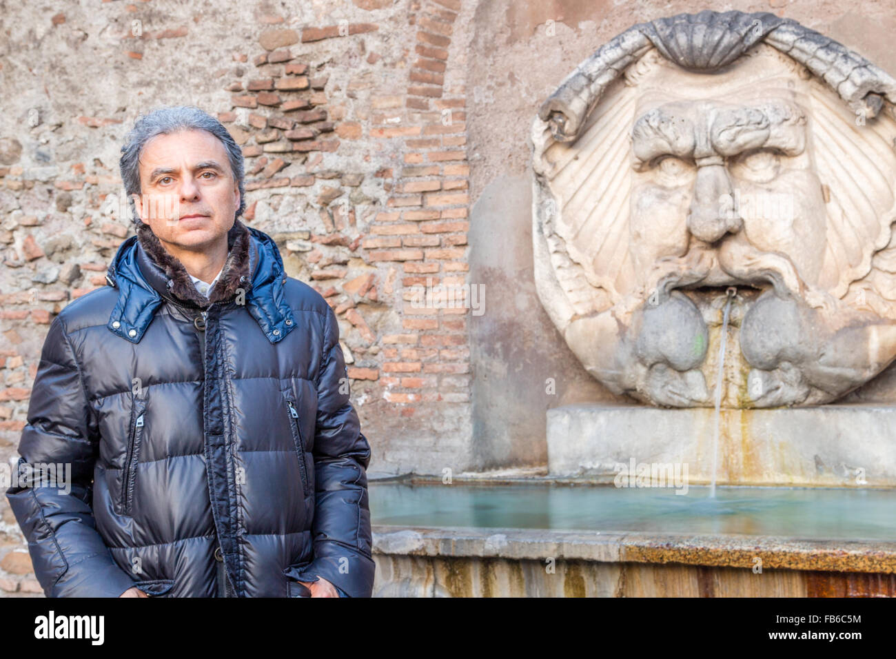 Mature man near ncient Roman fountain of the mask in Rome, Italy Stock ...