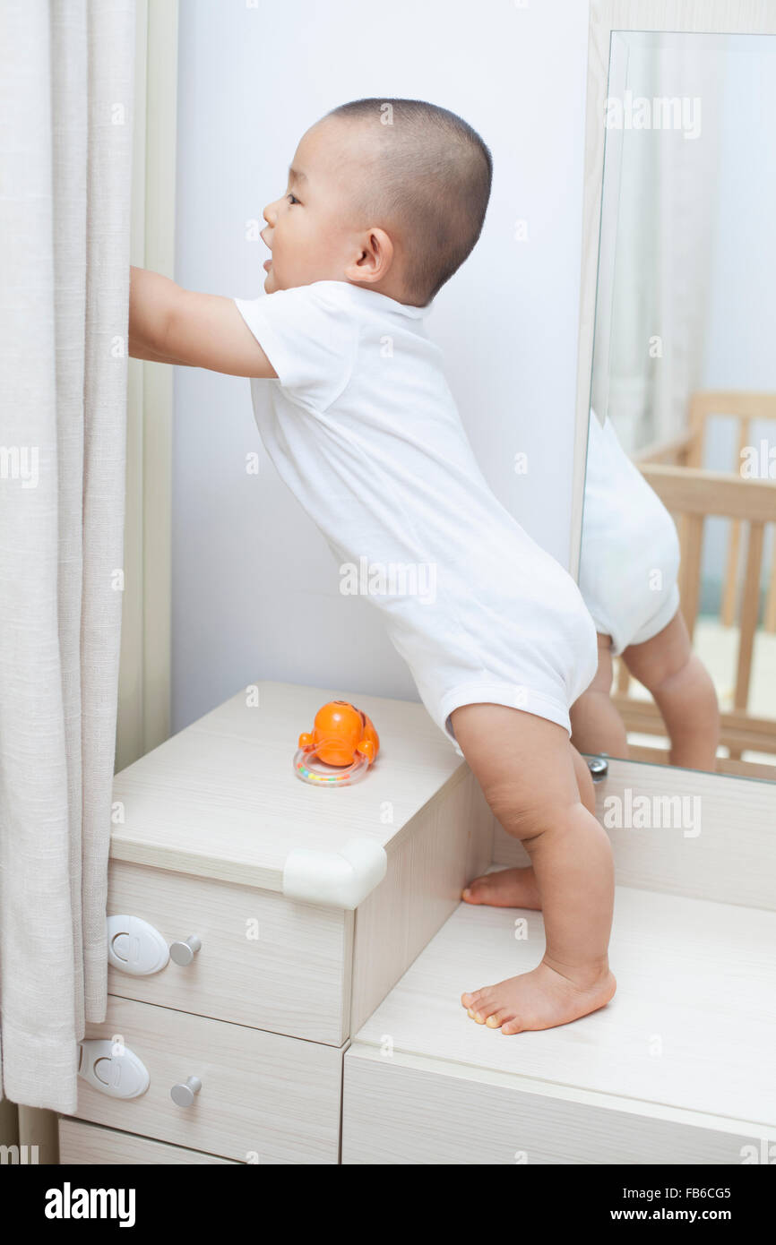 Chinese baby boy playing on a dressing table, shot in Beijing, China ...