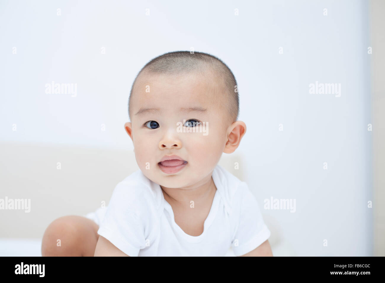 Cute Chinese baby boy crouching in bed, shot in Beijing, China Stock ...