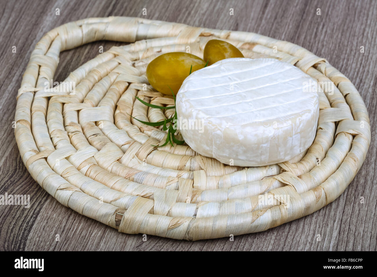 Round Brie cheese with yellow plums and estragon Stock Photo - Alamy