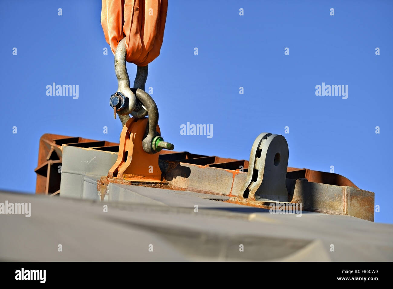 Heavy duty industrial chain hooked up on a construction crane for ...