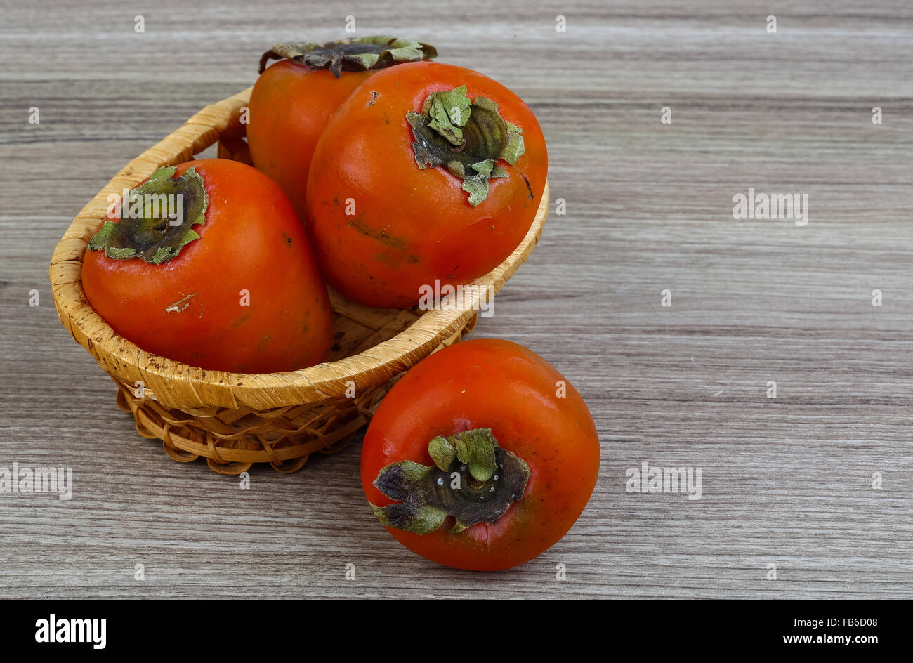 Fresh ripe juicy Persimmon fruit on the wood background Stock Photo - Alamy
