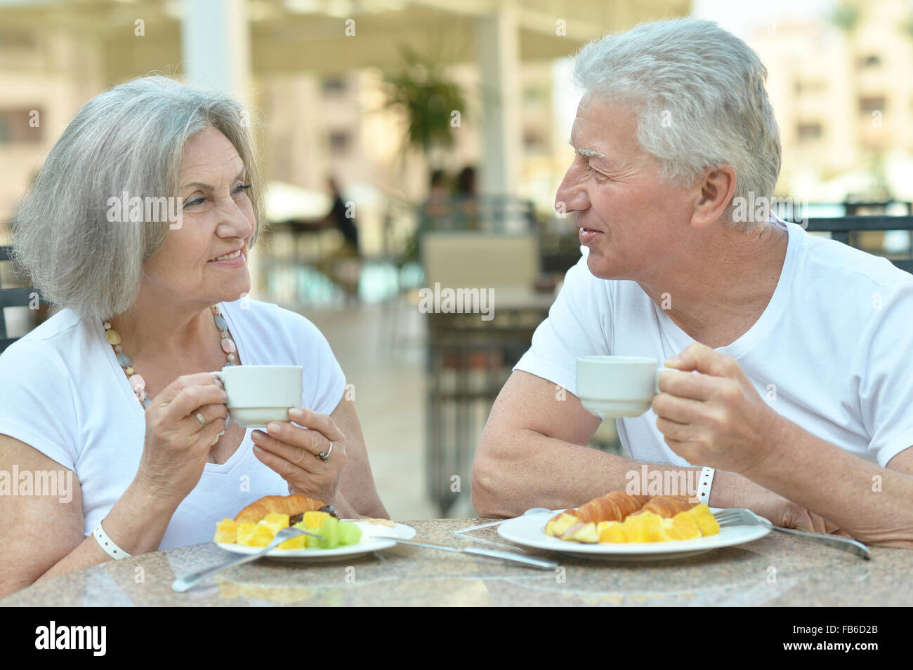 Older couple table having coffee hi-res stock photography and images ...