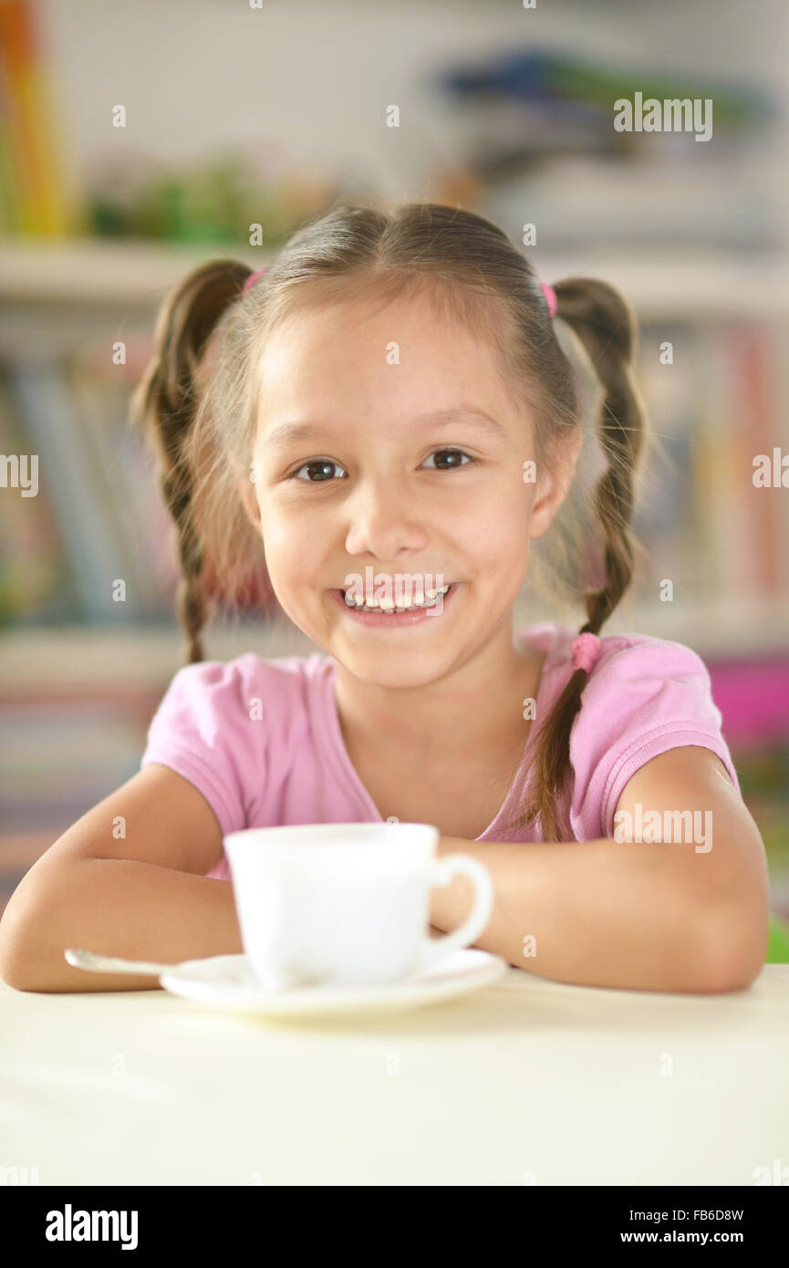 Cute little girl with cup Stock Photo - Alamy