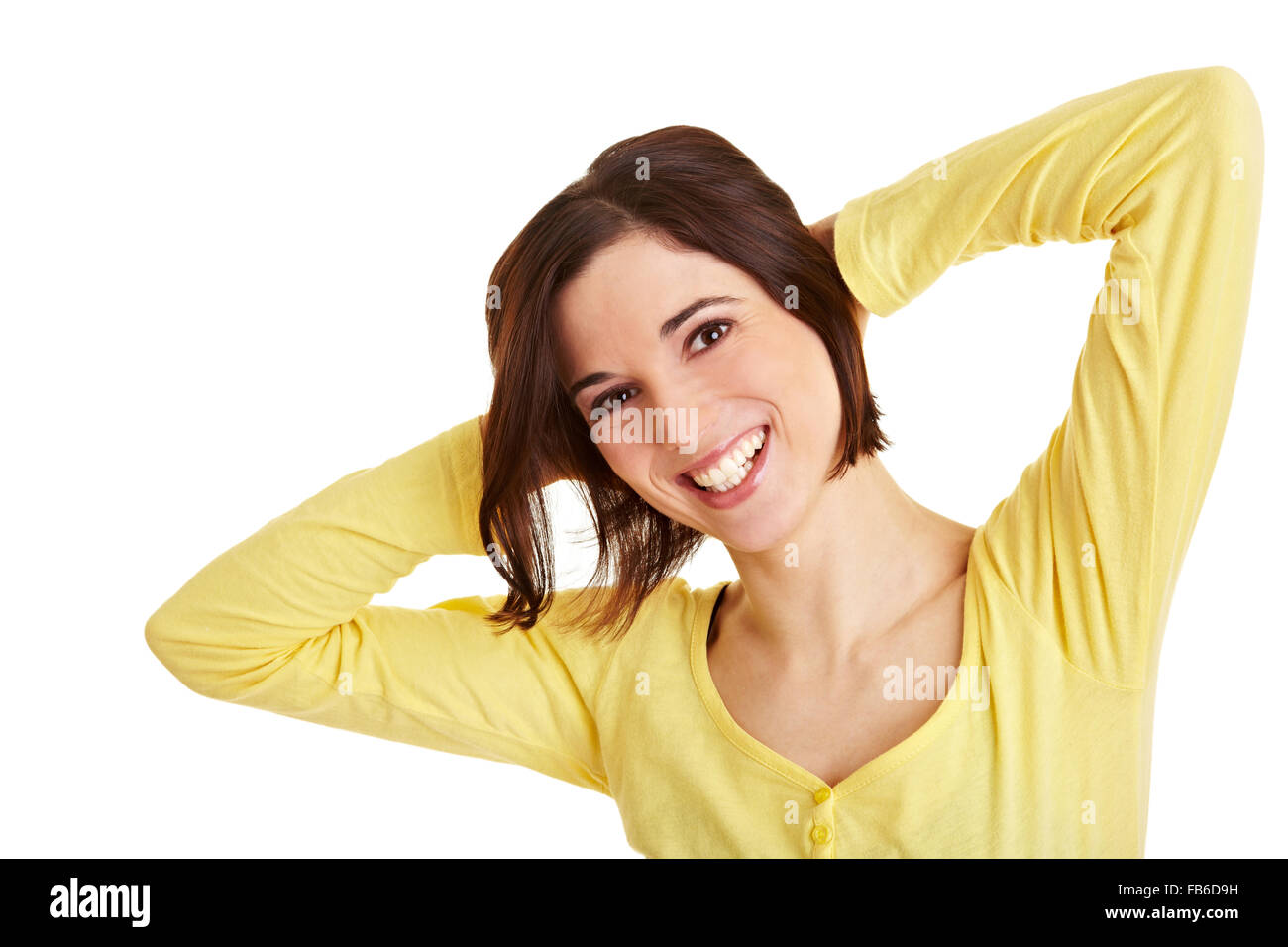 Happy smiling woman doing back exercises with arms behind her head ...
