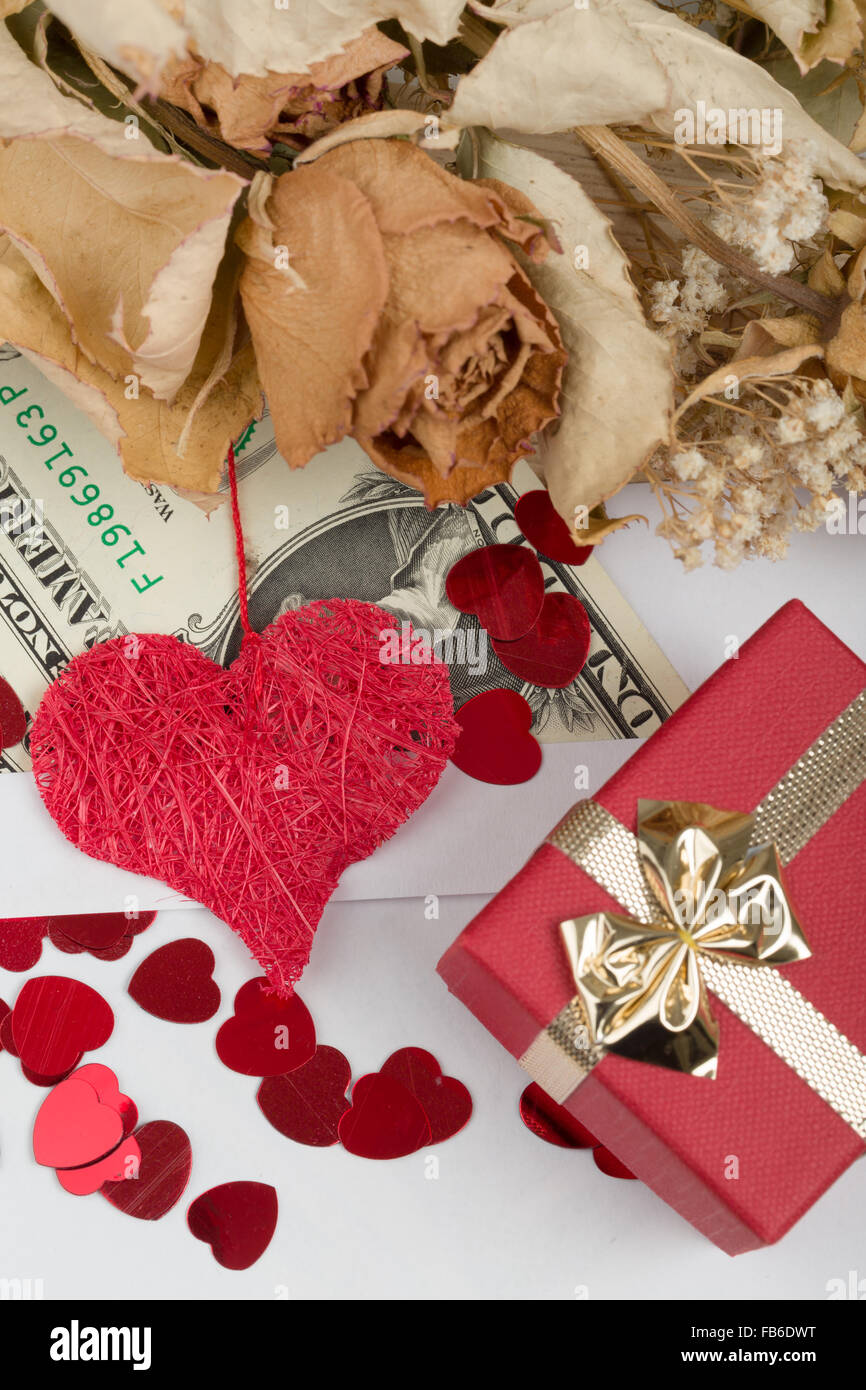 valentine concept with hearts, dry roses and us dollar banknotes as ...