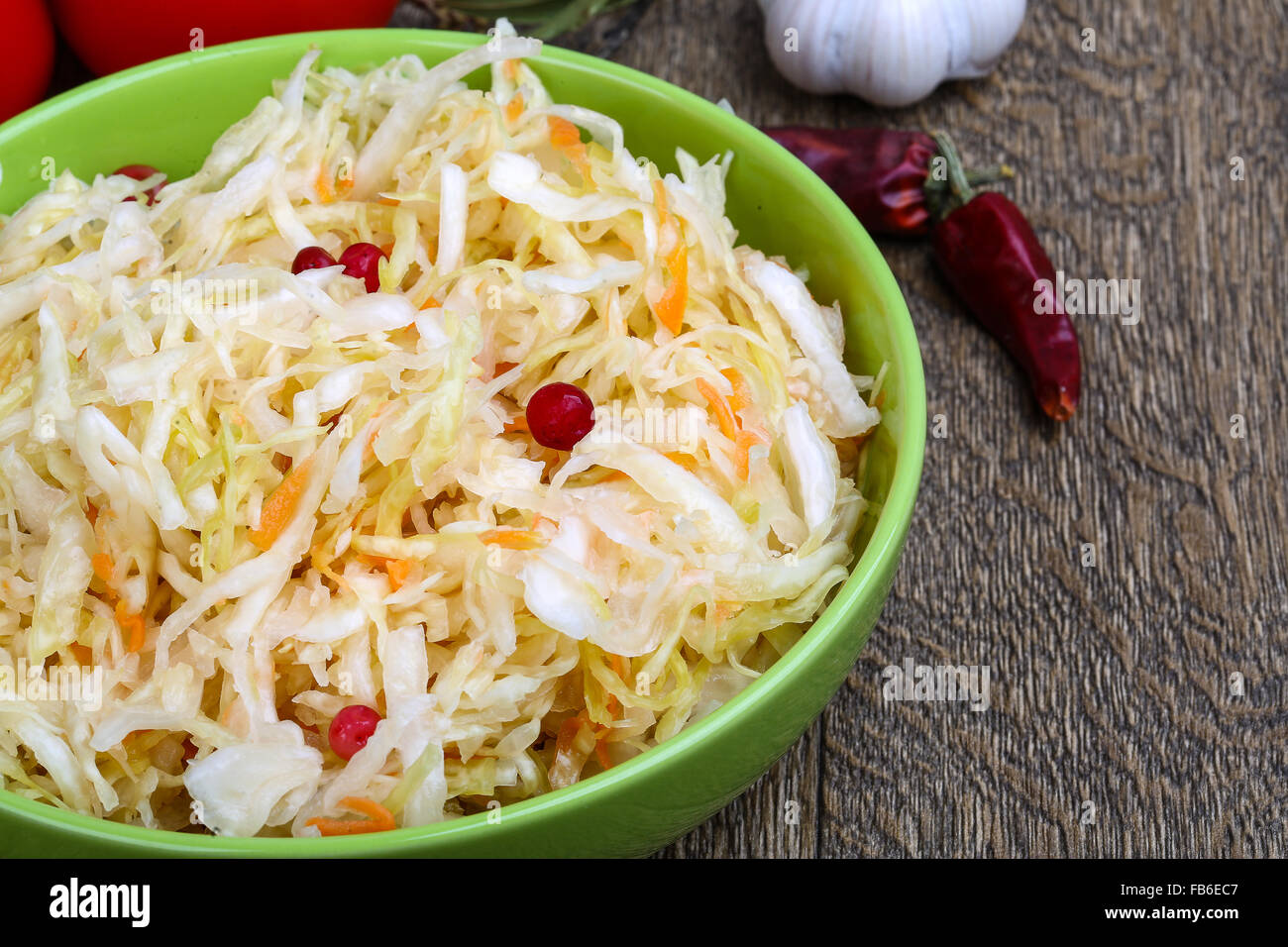 Fermented cabbage - Sauerkraut with herbs and spices on the wood ...