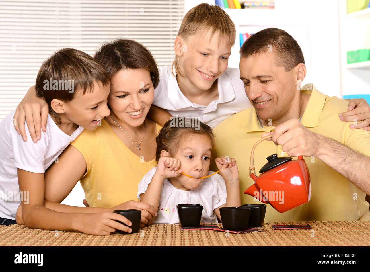 Family drinking tea Stock Photo - Alamy