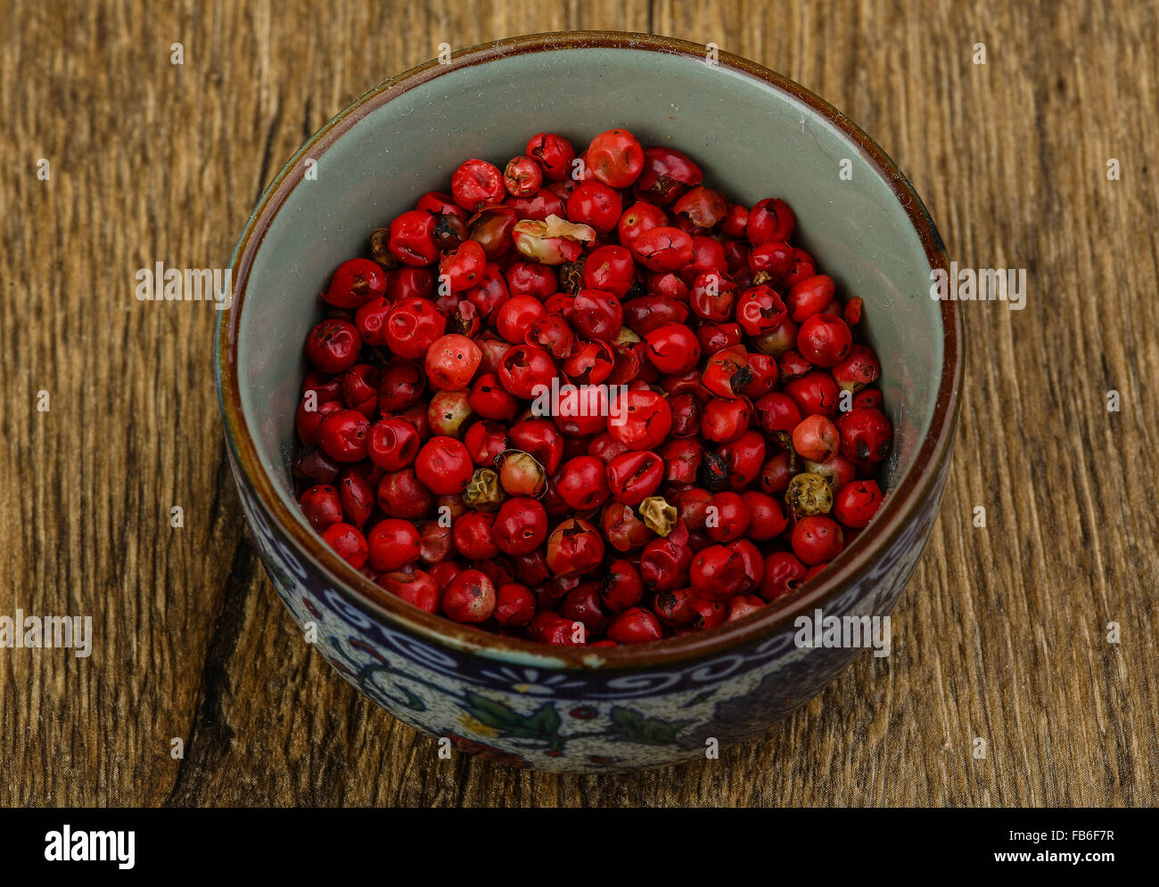 Dry Rose pepper corn on the wood background Stock Photo - Alamy