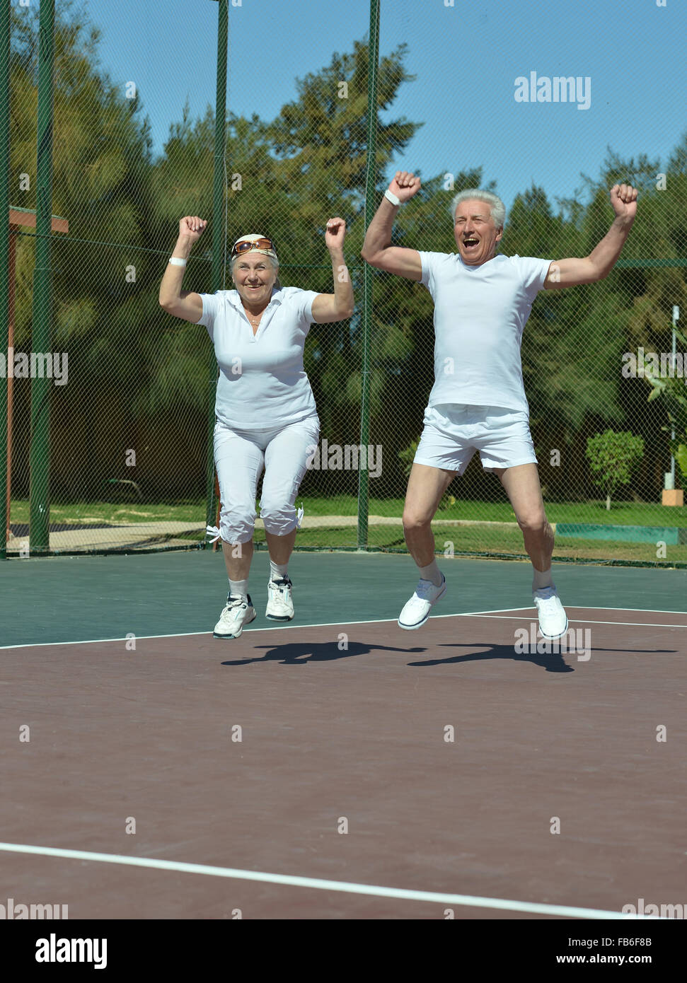 Senior couple win tennis Stock Photo - Alamy