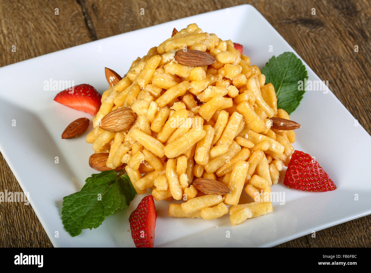 Tatar dessert chak-chak with almonds and strawberry Stock Photo - Alamy