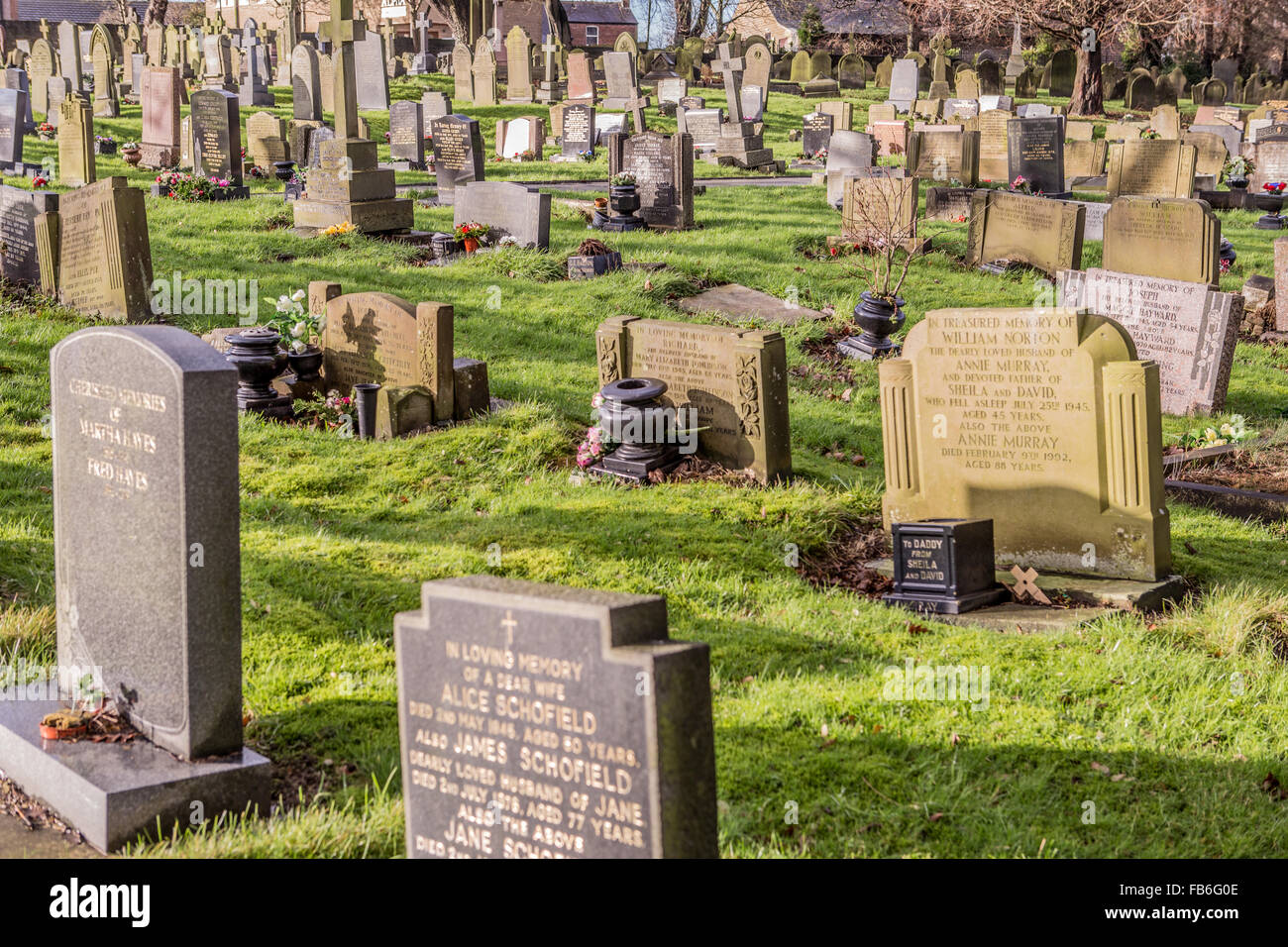 Gravestones in Standish parish church graveyard in winter on a sunny ...