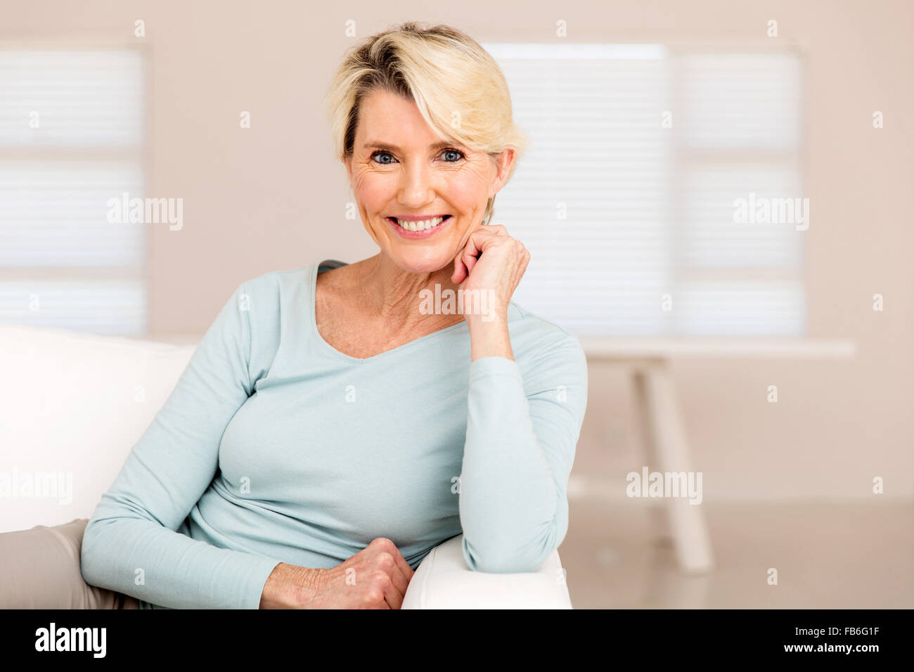 pretty mid age woman relaxing at home Stock Photo - Alamy