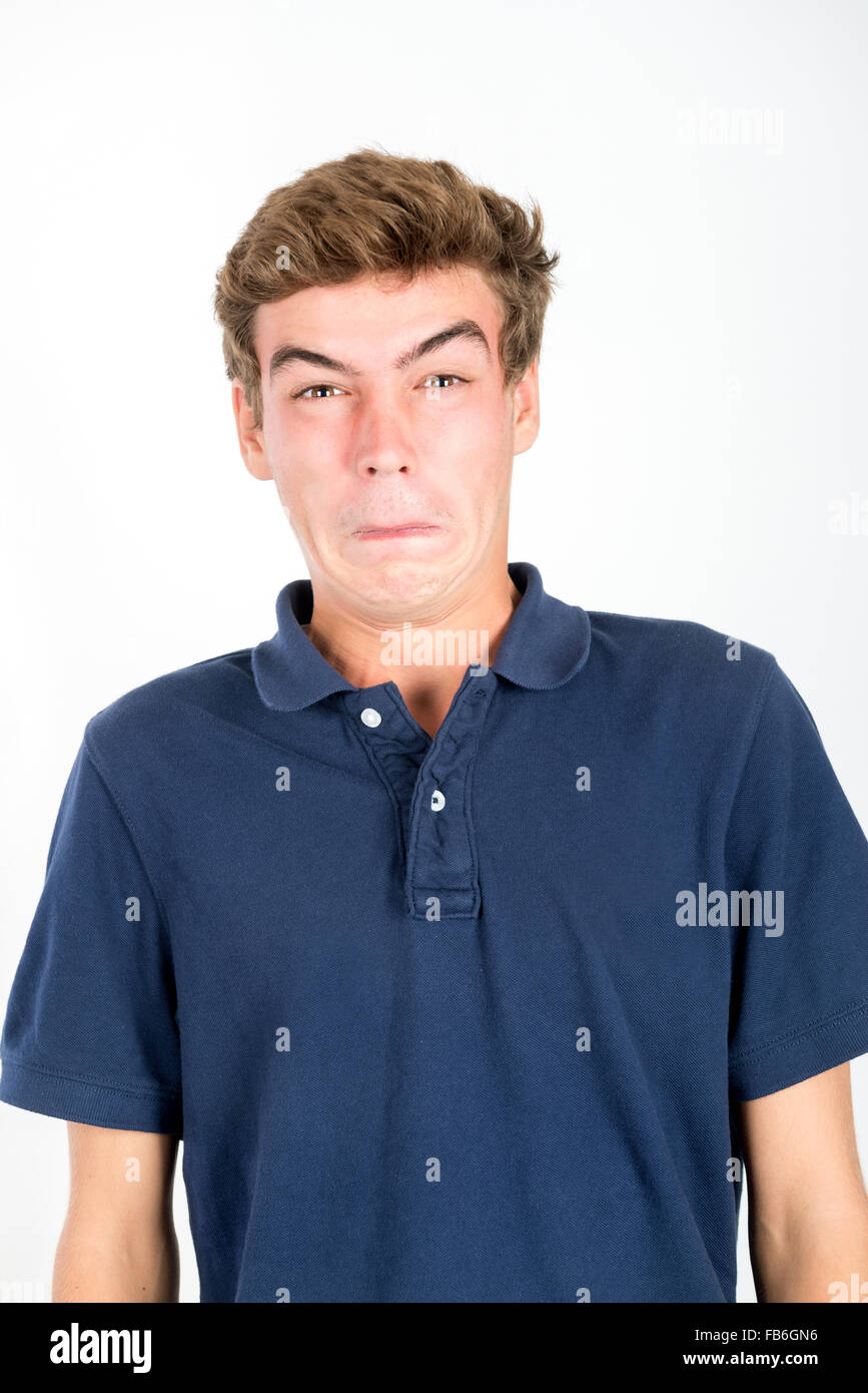 Disgusted teenage boy making faces isolated in white Stock Photo - Alamy