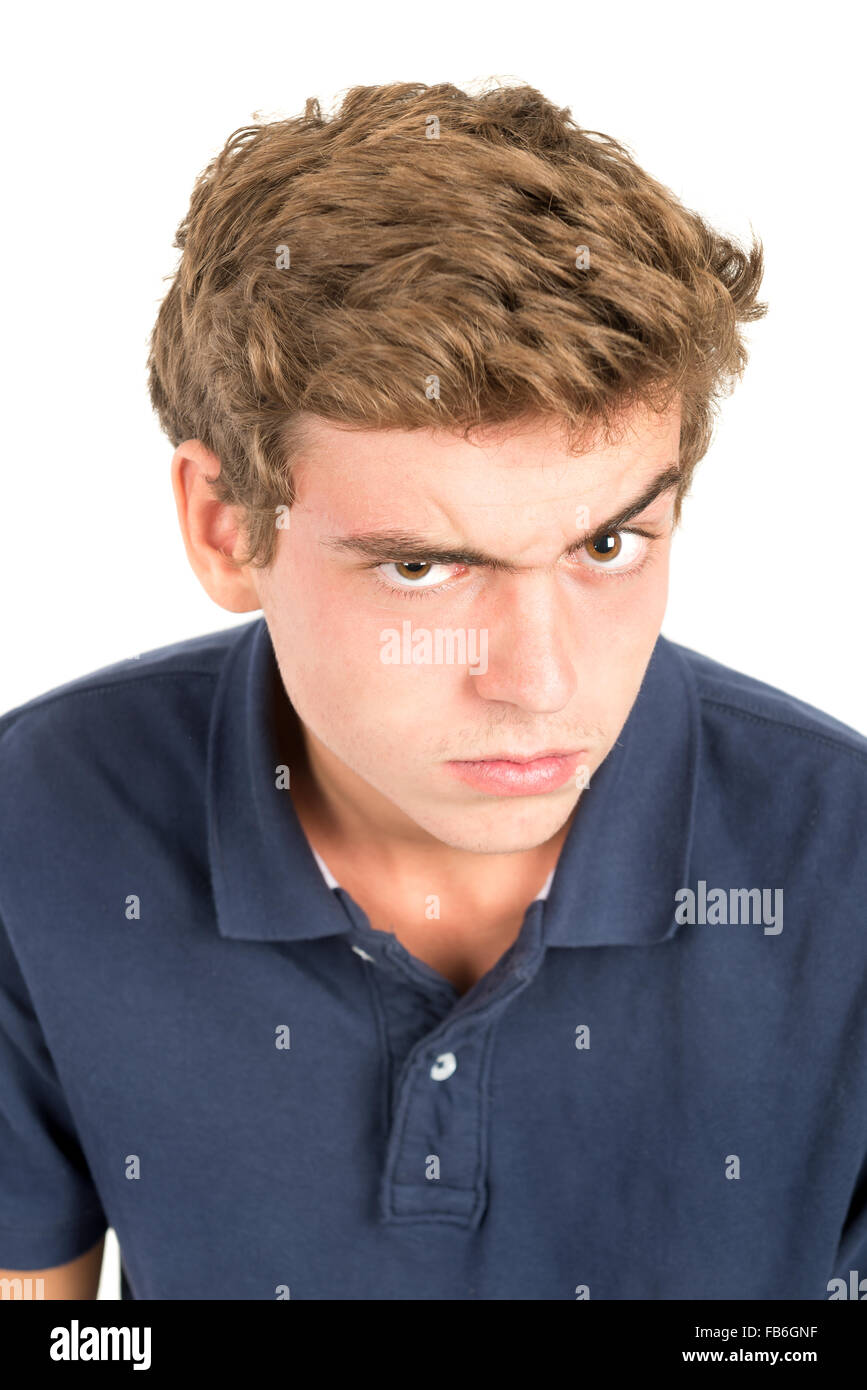 Angry teenage boy making faces isolated in white Stock Photo - Alamy
