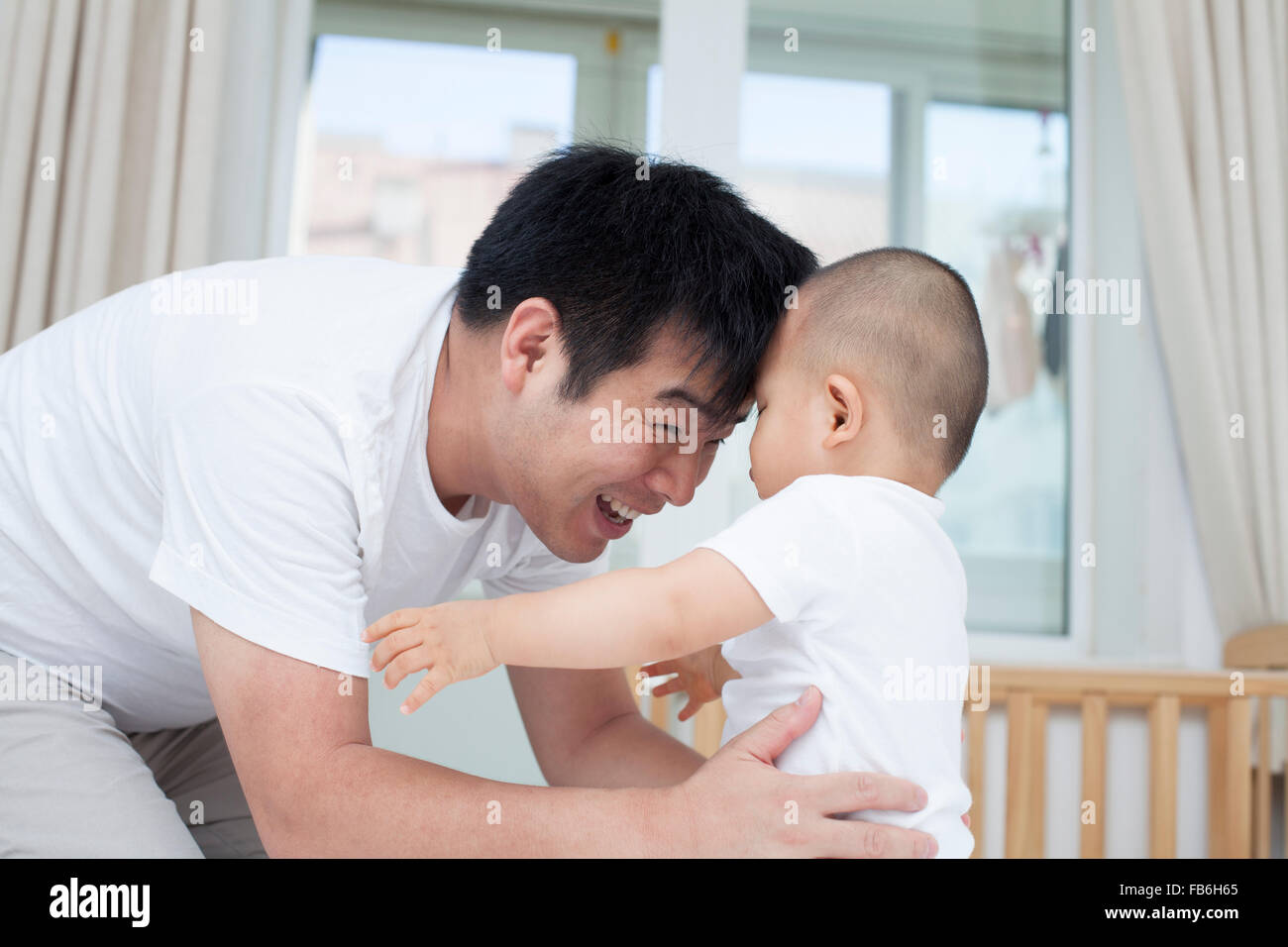 Tender moment between Chinese father and son, real people Stock Photo ...