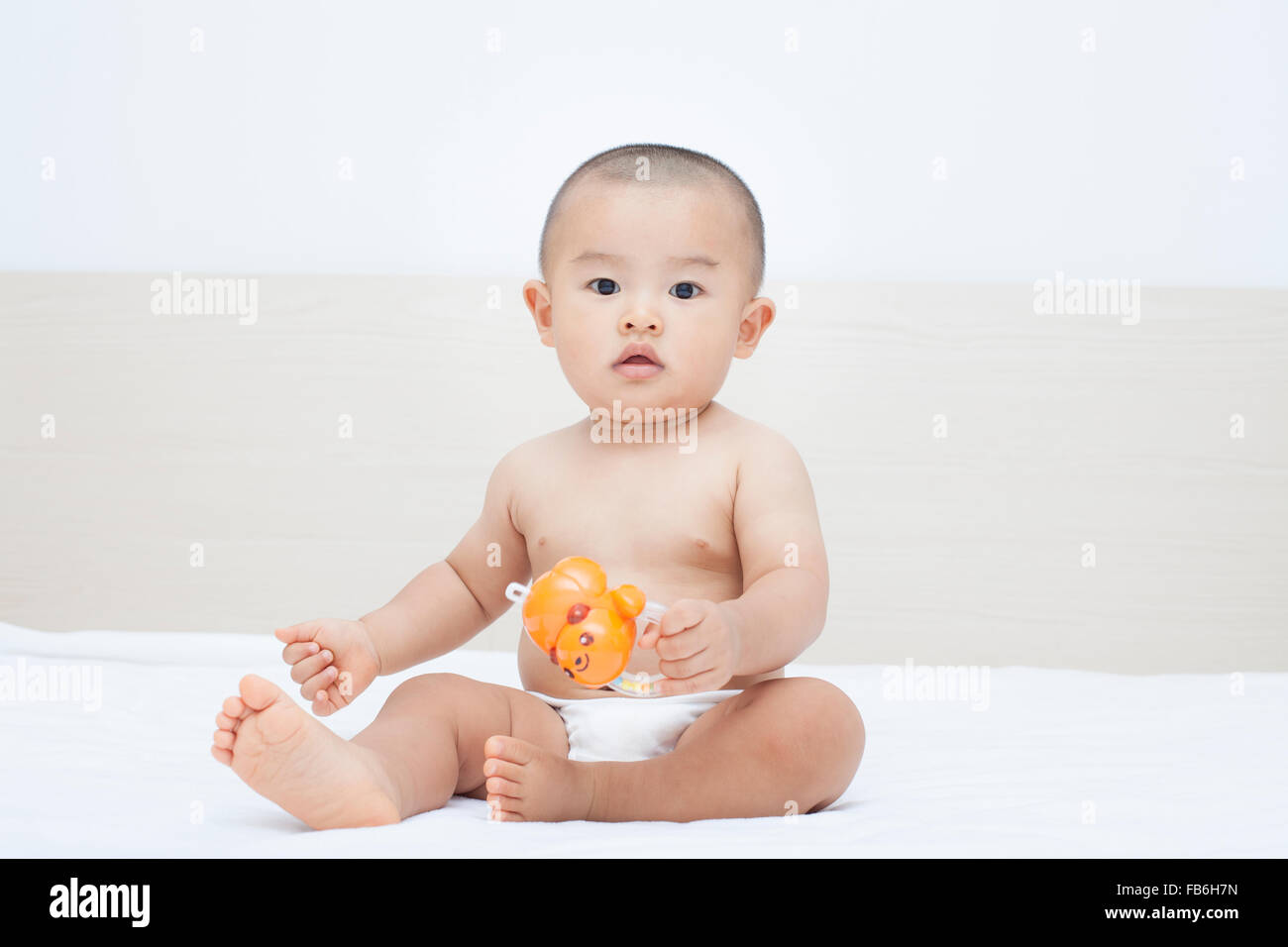 Cute Chinese baby boy sitting in bed, shot in Beijing, China Stock ...