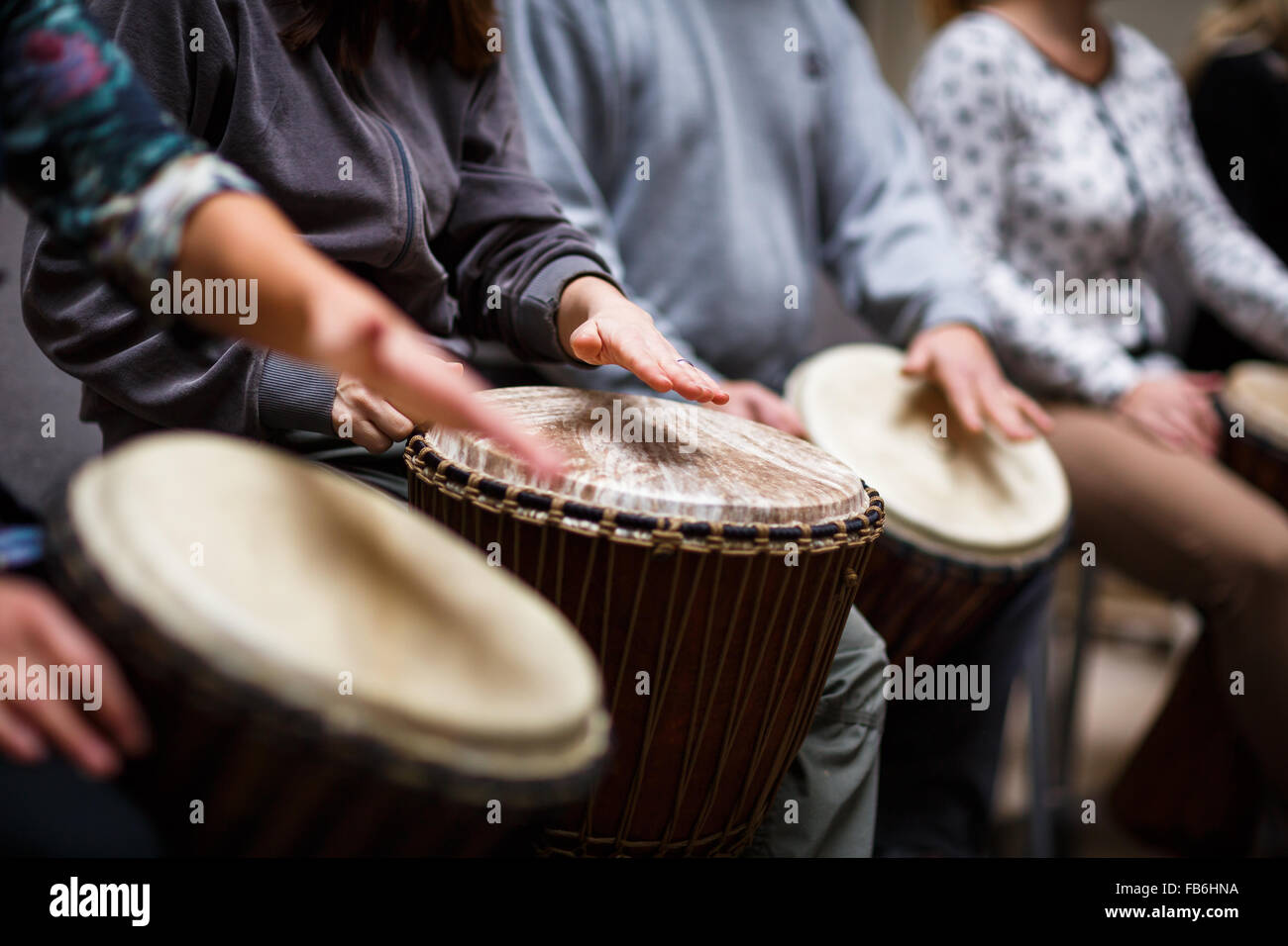 Group of people playing on drums - therapy by music Stock Photo - Alamy