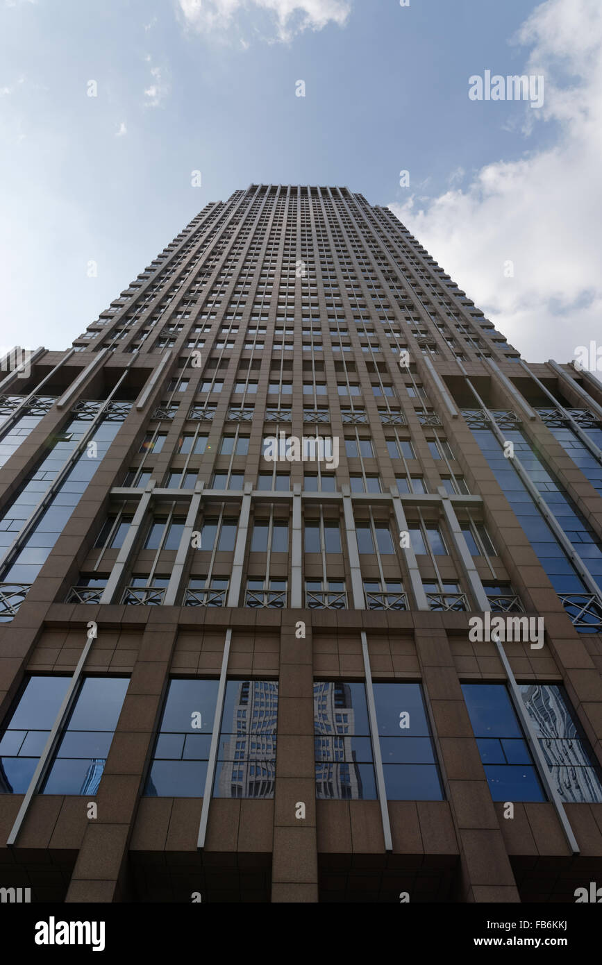 Bottom view of tall business skyscraper shot from the ground to the sky ...