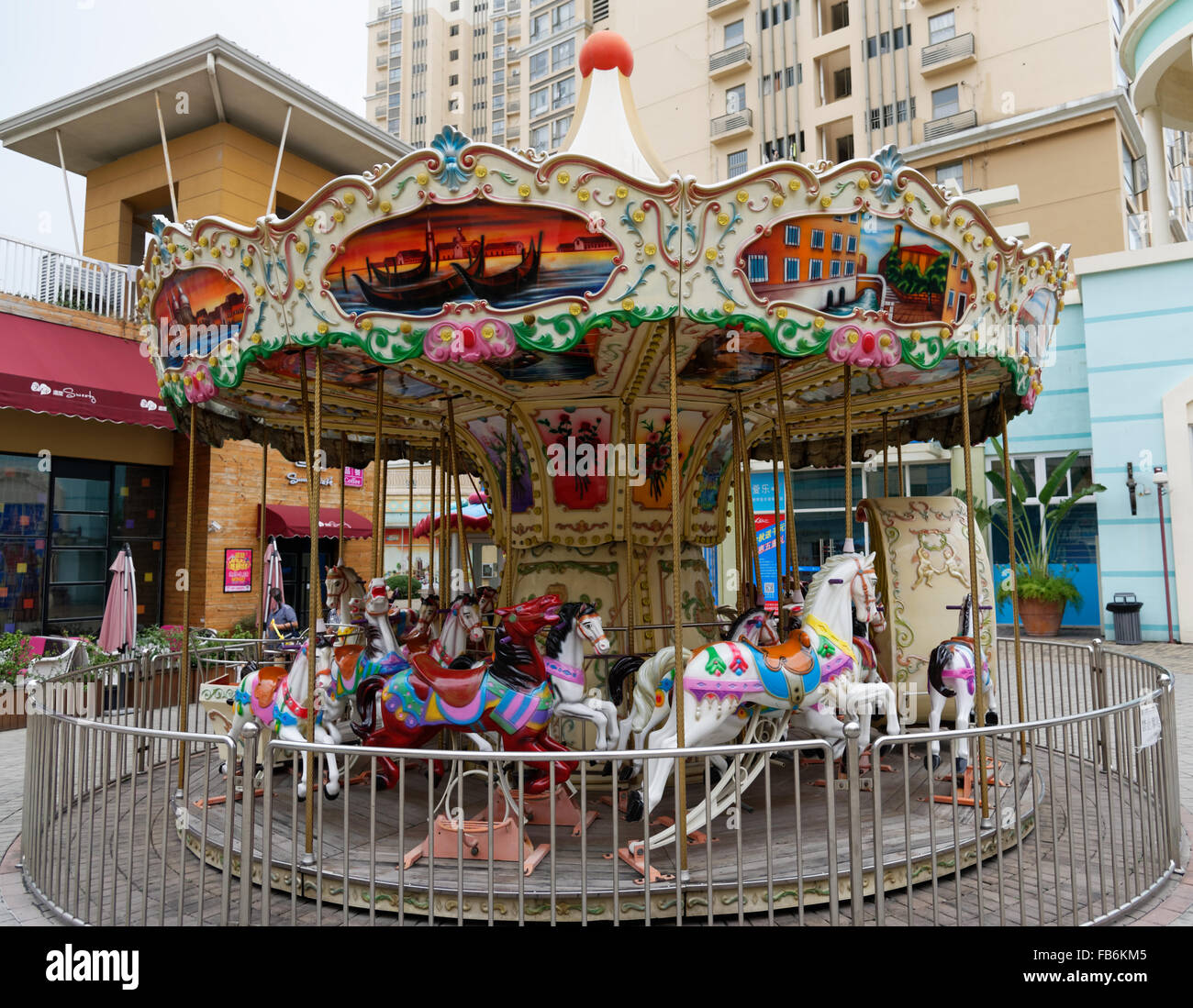 Colourful carousel with horses on a street Stock Photo - Alamy