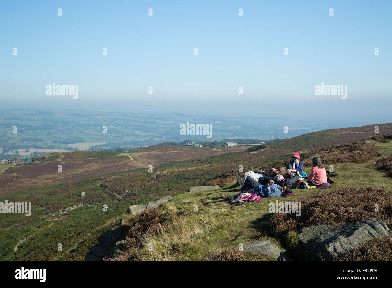 A group of people look over the amazing view of Ilkley from the top of ...